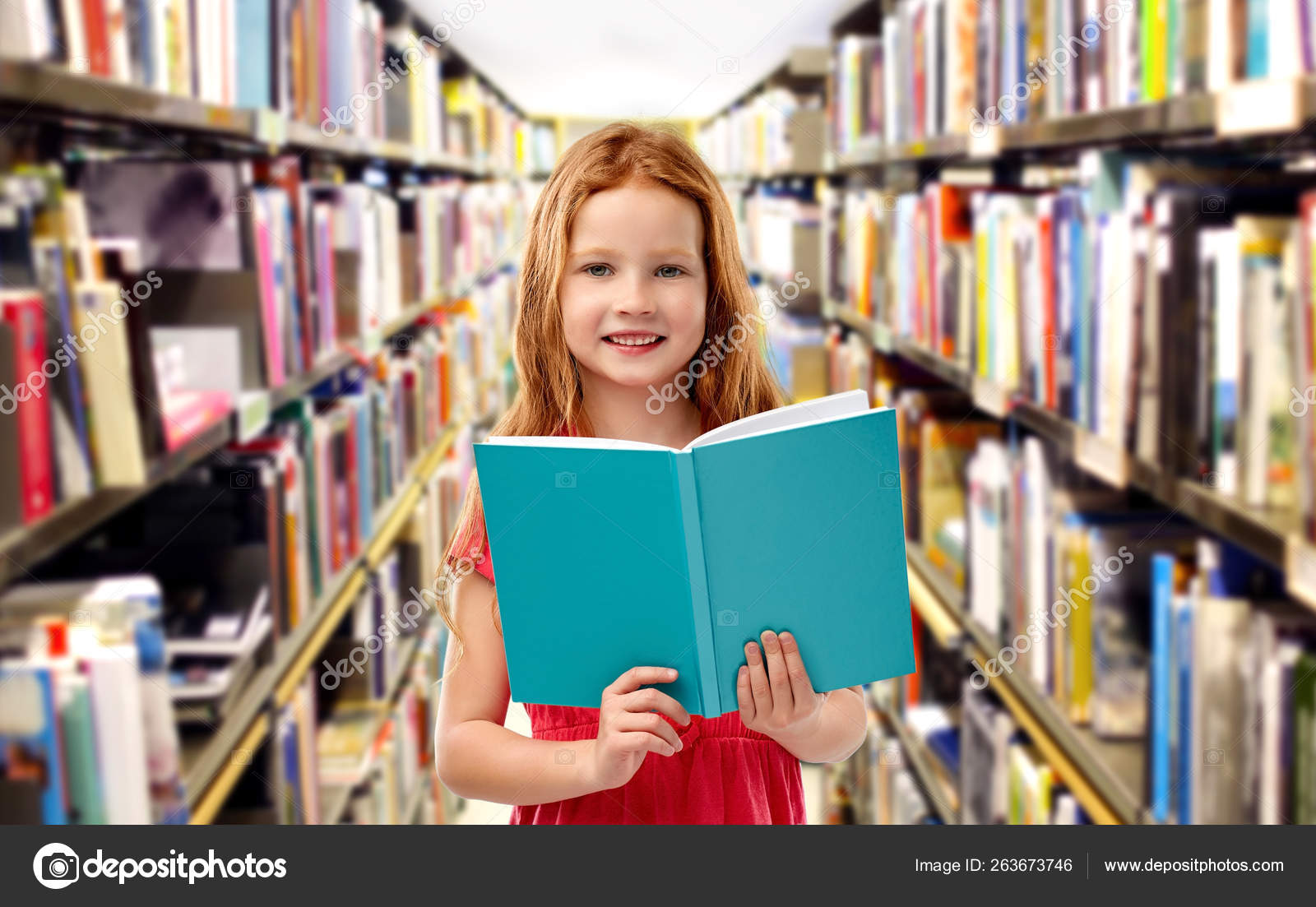 Smiling red haired girl reading book at library — Stock Photo © Syda ...