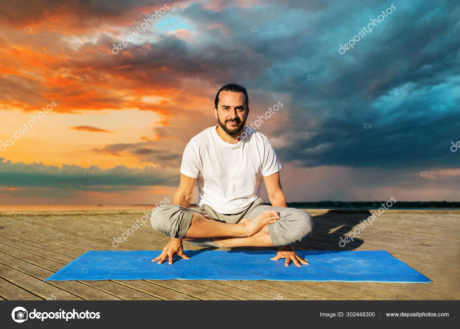 Man making yoga in scale pose outdoors Stock Photo by ©Syda_Productions ...