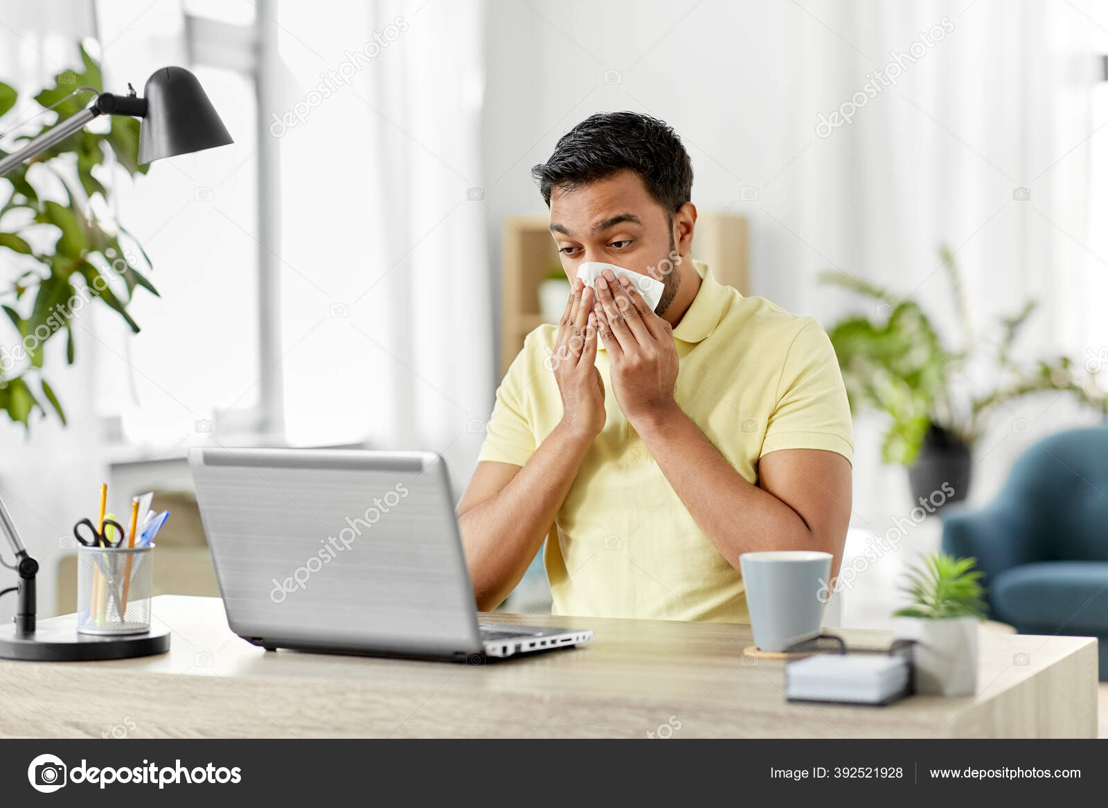 Indian man with laptop blowing nose at home office Stock Photo by ©Syda ...