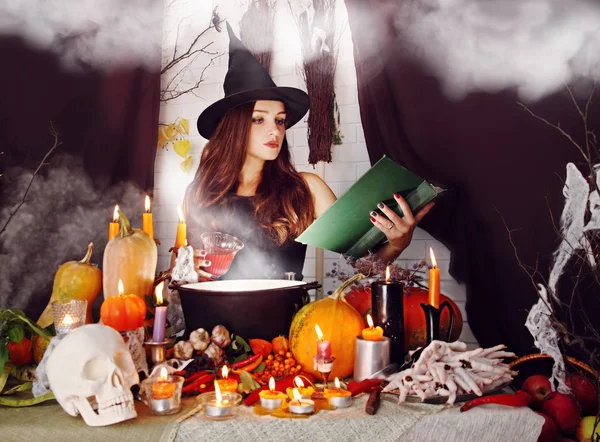 beautiful Witch brew the potion in the boiler - Stock Image - Everypixel