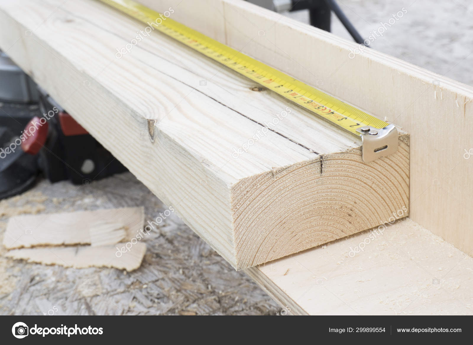 Two by four pinewood bar and yellow tape measure. Measurement pr ...