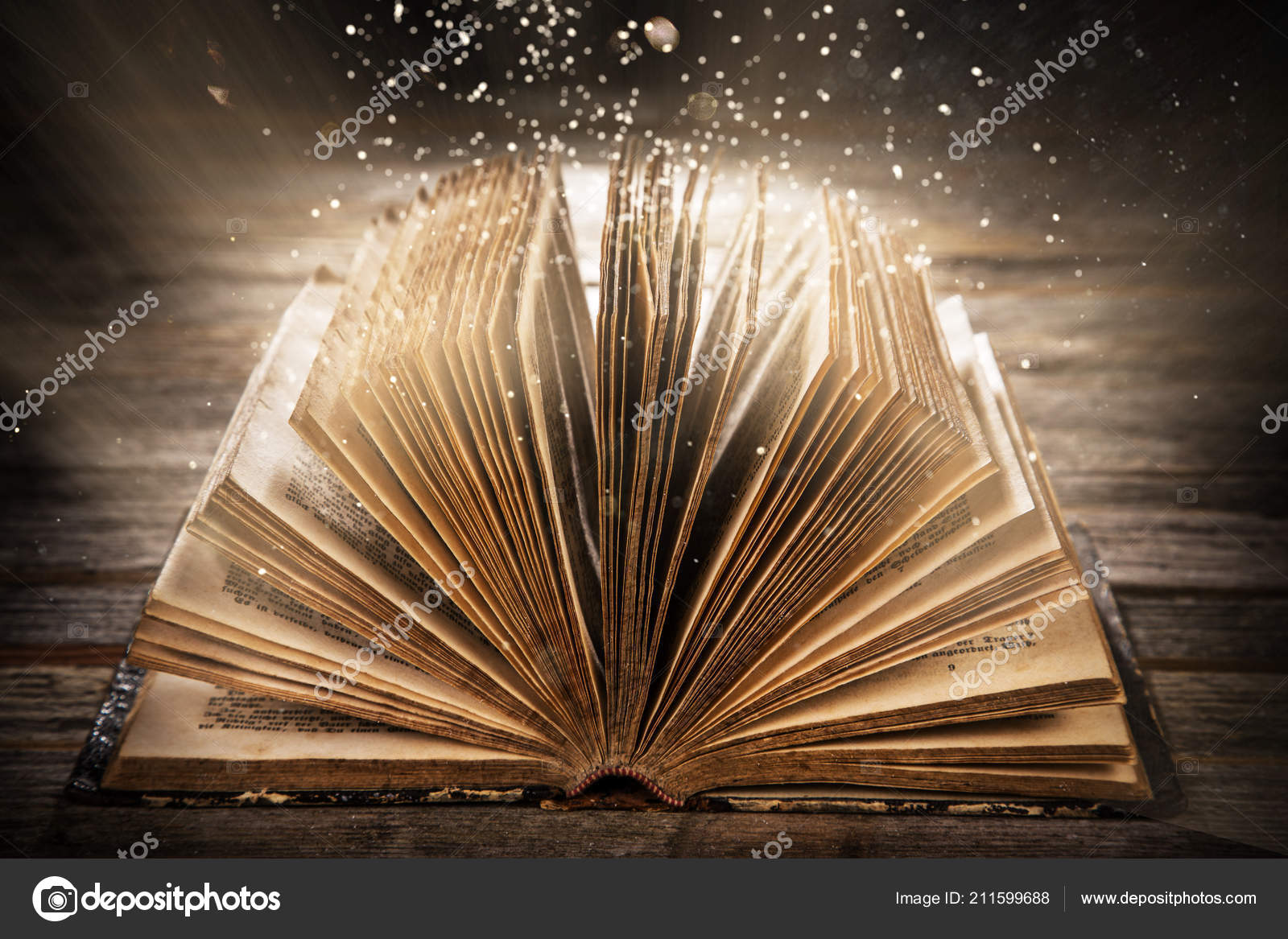 Old open book on wooden table with mystic magic bright light. Stock ...