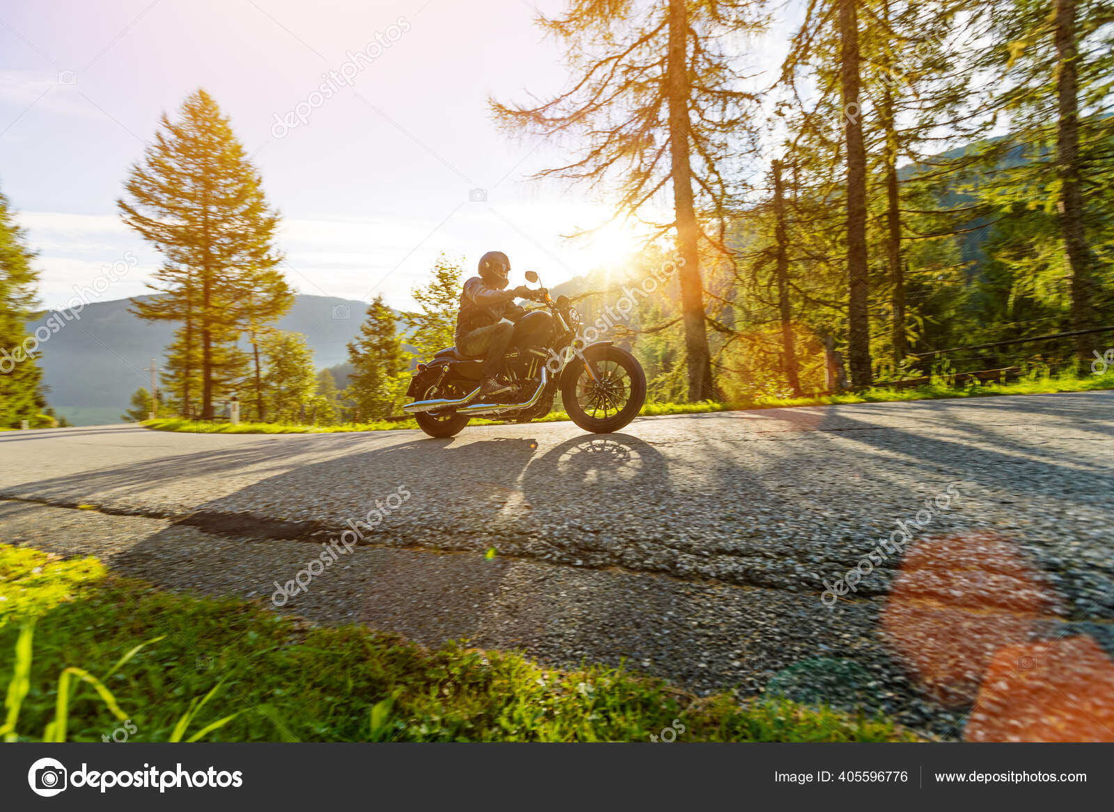 Motorcycle rider driving in Alps, beautiful nature with clear sky ...