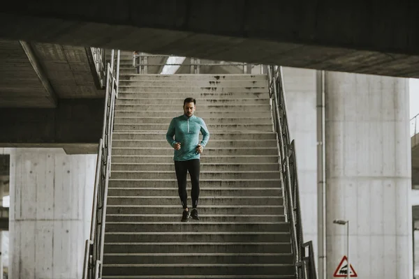 Young man running fast down the stairs in the city - Stock Image ...