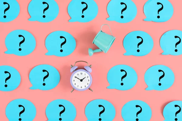 blue stickers with question marks, small alarm clock and a blue ...