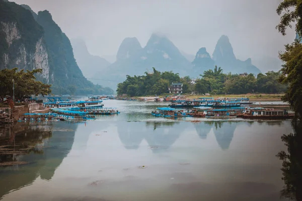 Li River (Lijiang River). Pleasure boats at the pier in Xingping Town ...