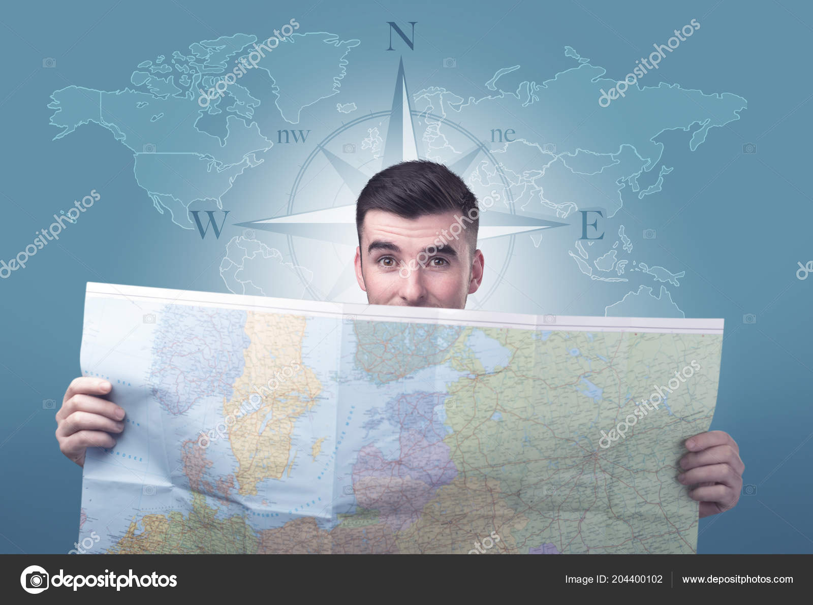 Young man holding map Stock Photo by ©ra2studio 204400102