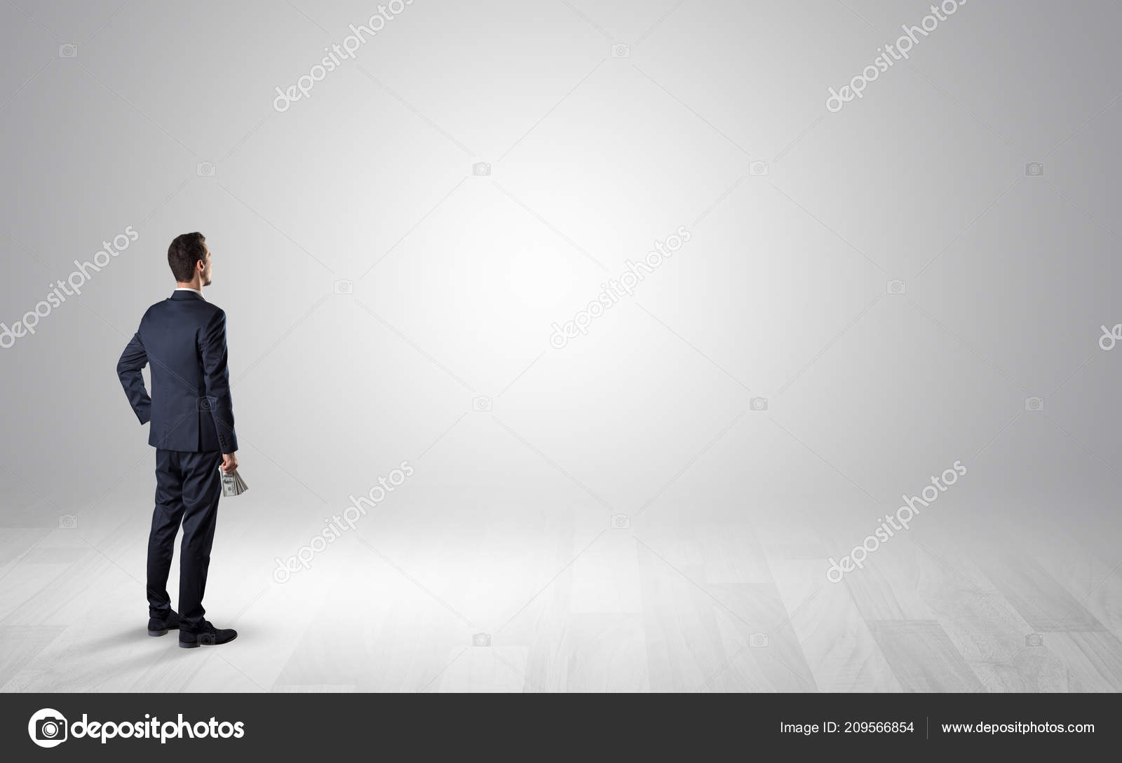 Man with object in his hand in an empty space — Stock Photo © ra2studio ...