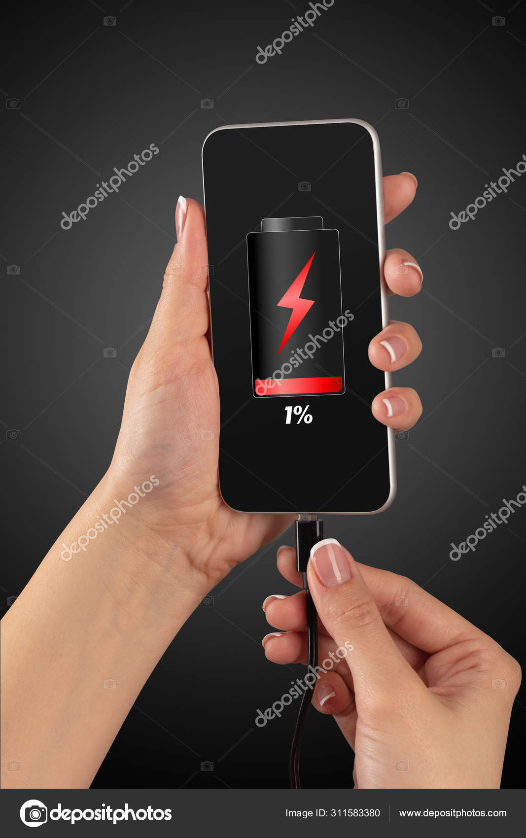 Hand charging phone with low battery Stock Photo by ©ra2studio 311583380