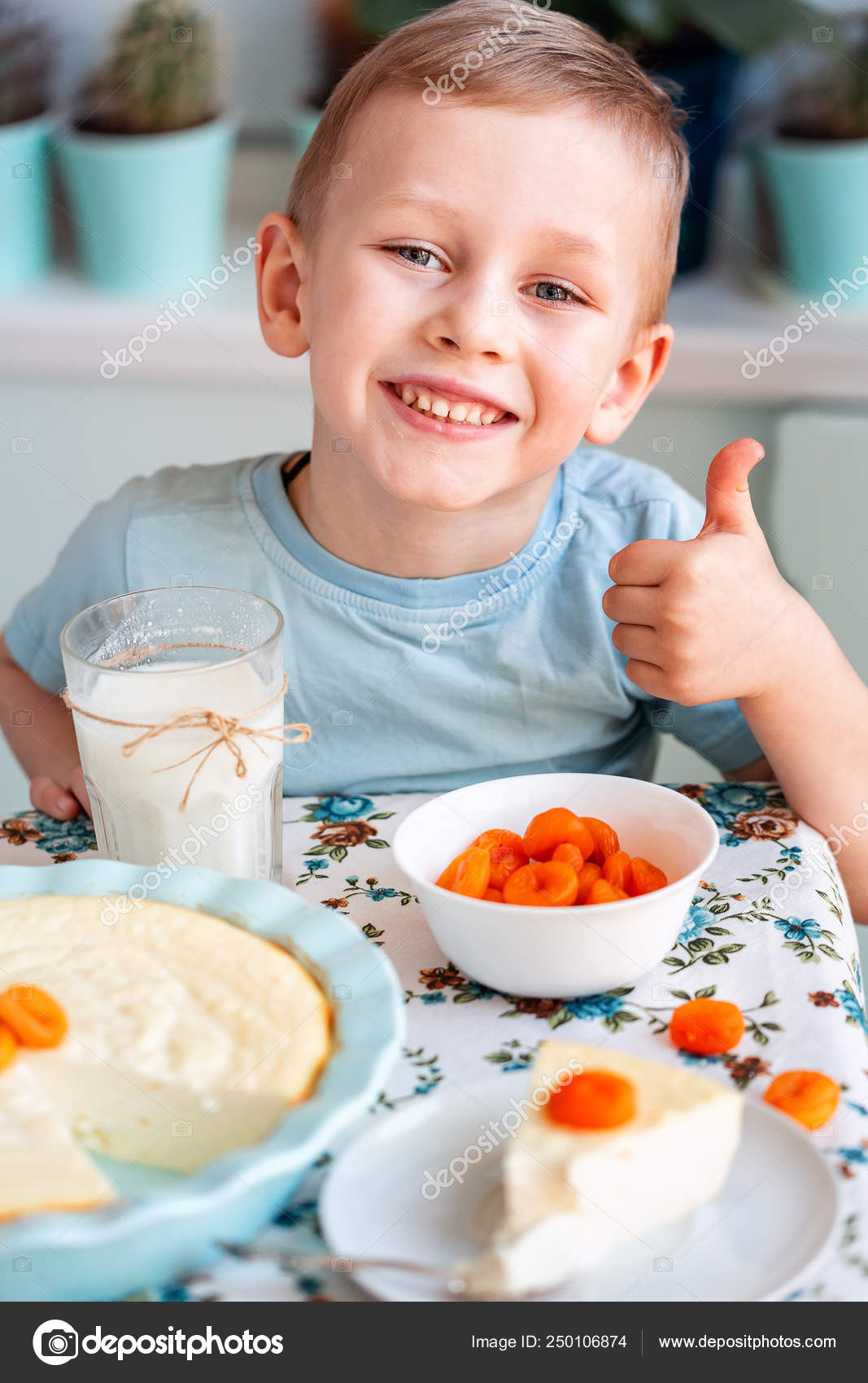 Beautiful little boy eating breakfast in kitchen at home Stock Photo by ...