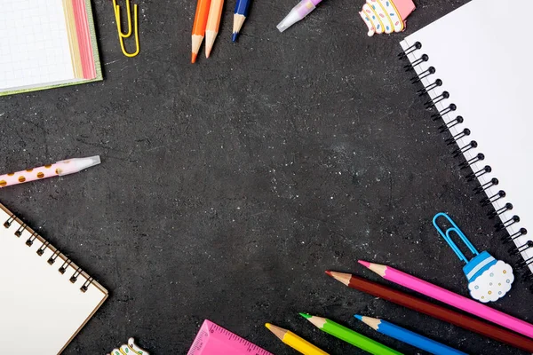 Stationery formed a frame on a black background. Back to school concept ...