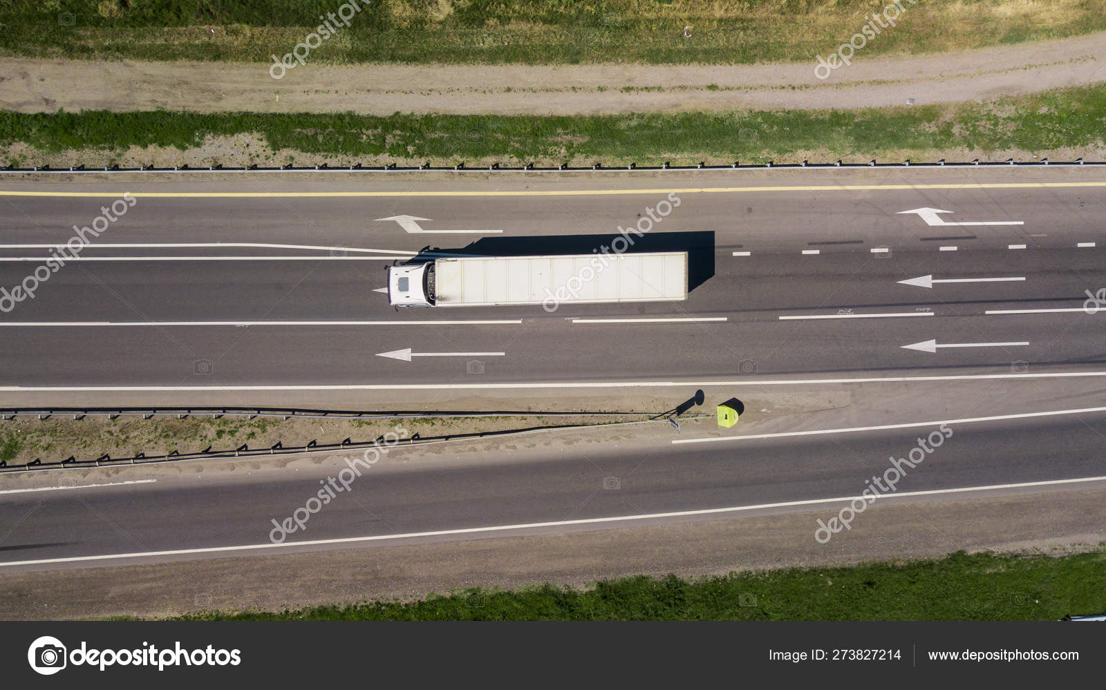 Top down close up of road, asphalt, white arrow signs indicating ...
