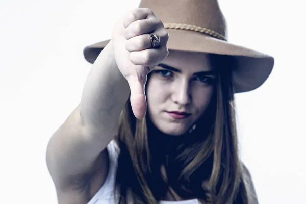 Everything is bad. Woman showing her thumb finger down as symbol of ...