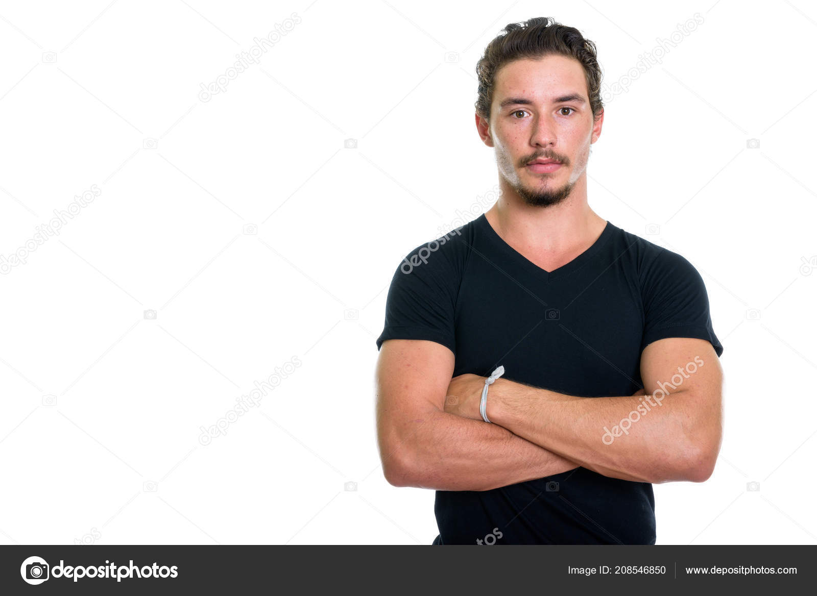 Studio shot of young handsome man with arms crossed isolated aga ...