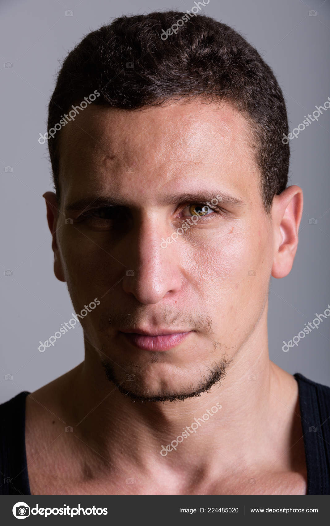 Face of young muscular Persian man against gray background Stock Photo ...