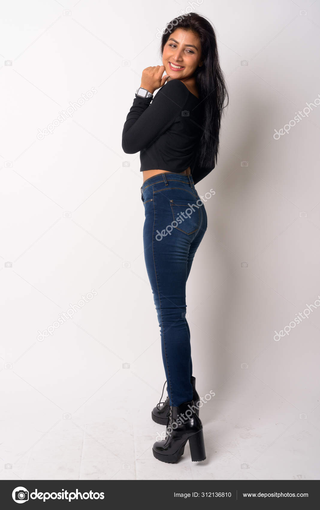 Full body shot profile view of happy young Persian woman looking back ...