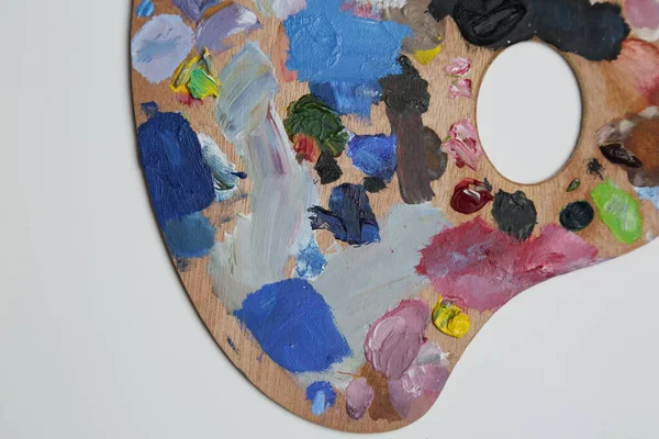 Lovely artist's palette with some oil paints of different texture and ...