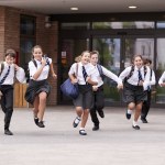 Group High School Students Wearing Uniform Running Out School Buildings ...