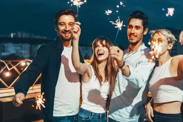 Friends enjoying a rooftop party - Stock Image - Everypixel
