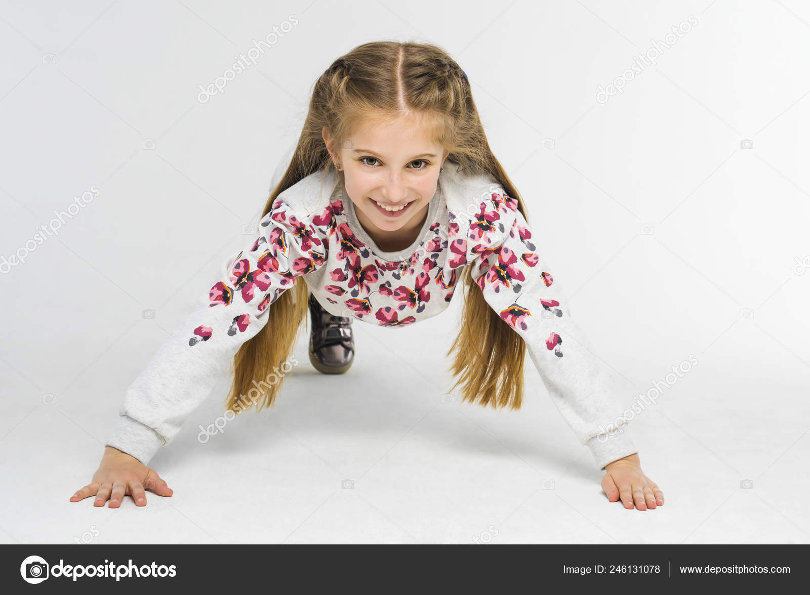 Little girl doing push-ups on light background Stock Photo by ©GekaSkr ...