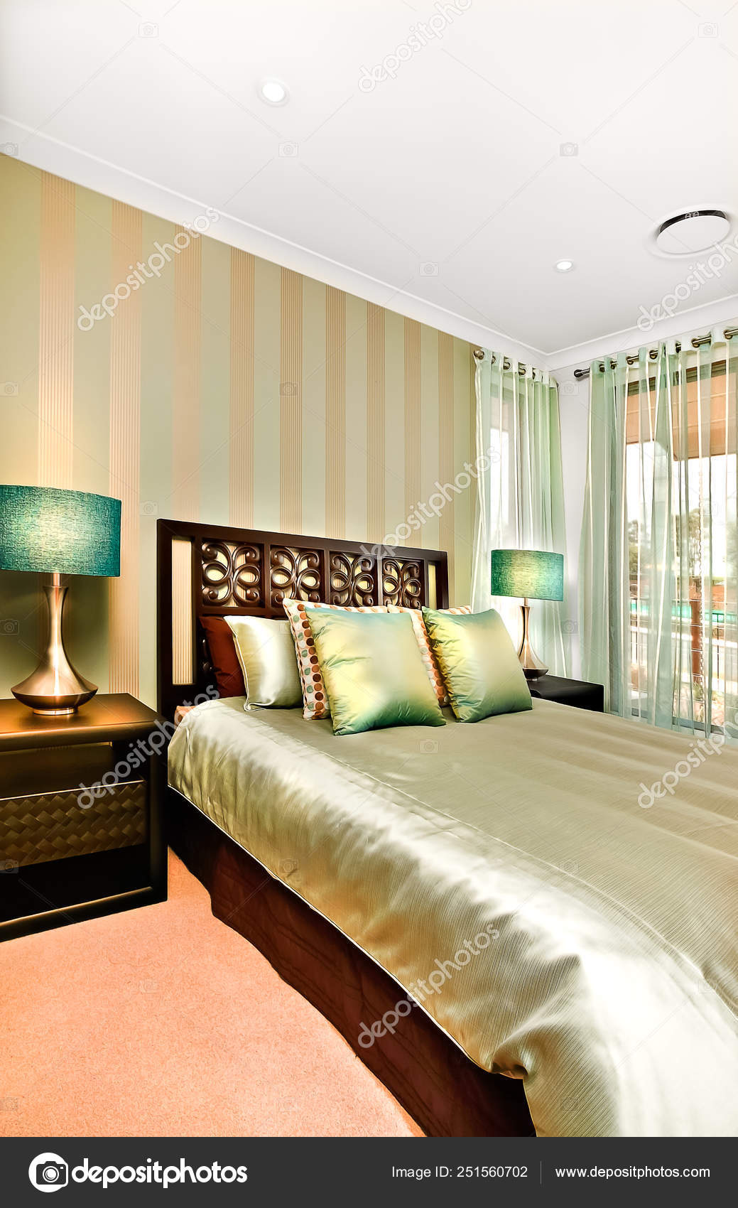 Side view of a king size bed that has gloss pillows and a bed sh ...