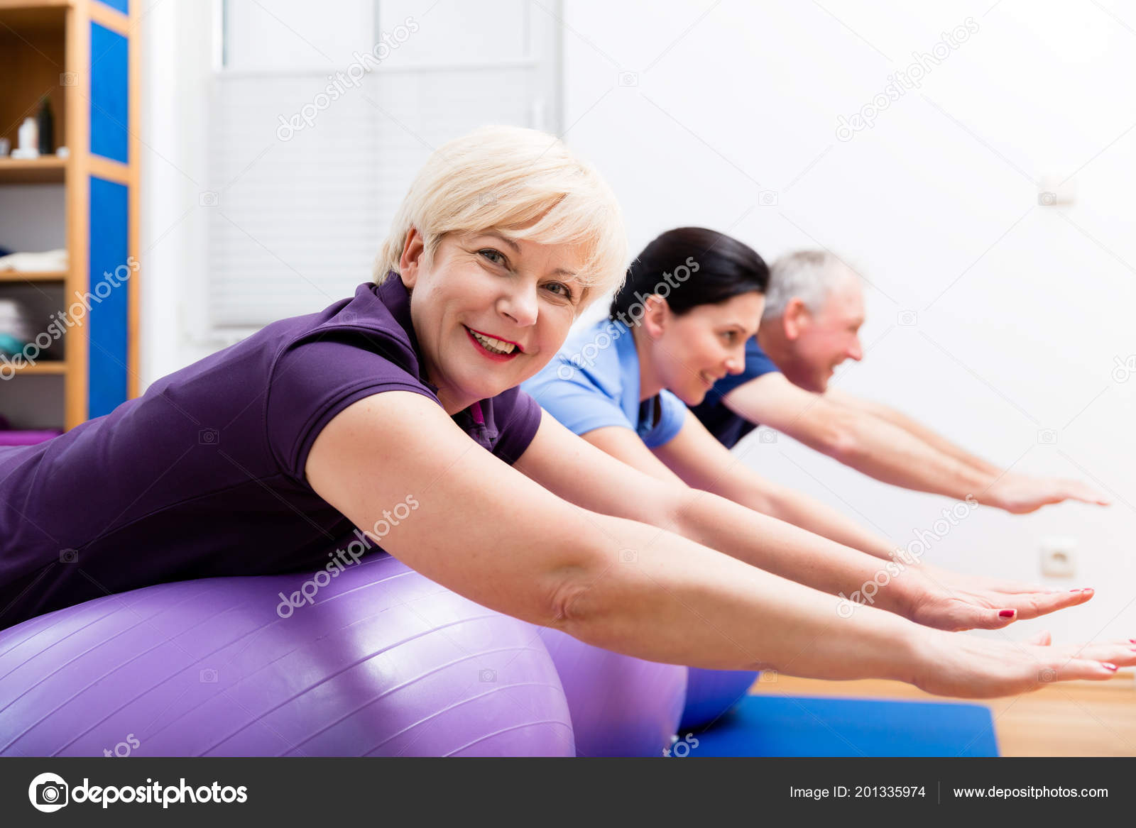 Physio showing senior couple how to use gym ball for exercises — Stock Photo © Kzenon #201335974