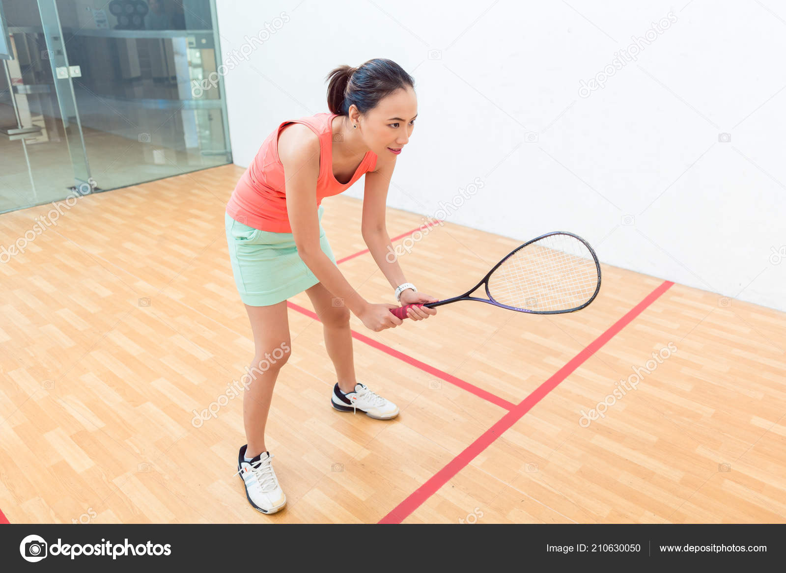 Young squash player holding the racket during game on a professional ...