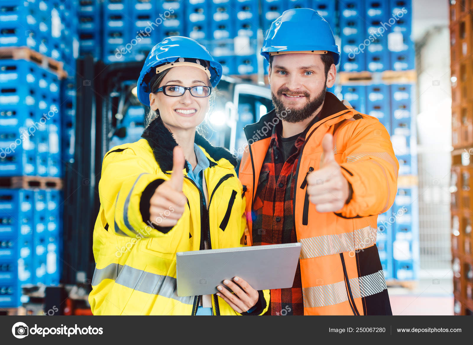 Workers in logistics distribution center showing thumbs-up Stock Photo ...