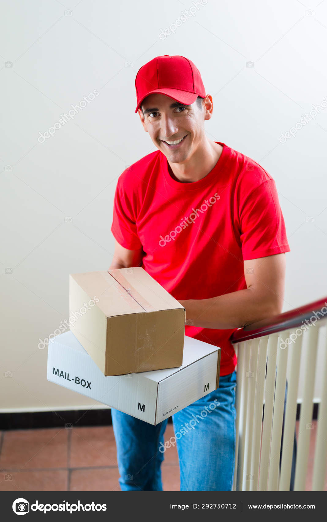 Delivery man holding two cardboard boxes Stock Photo by ©Kzenon 292750712