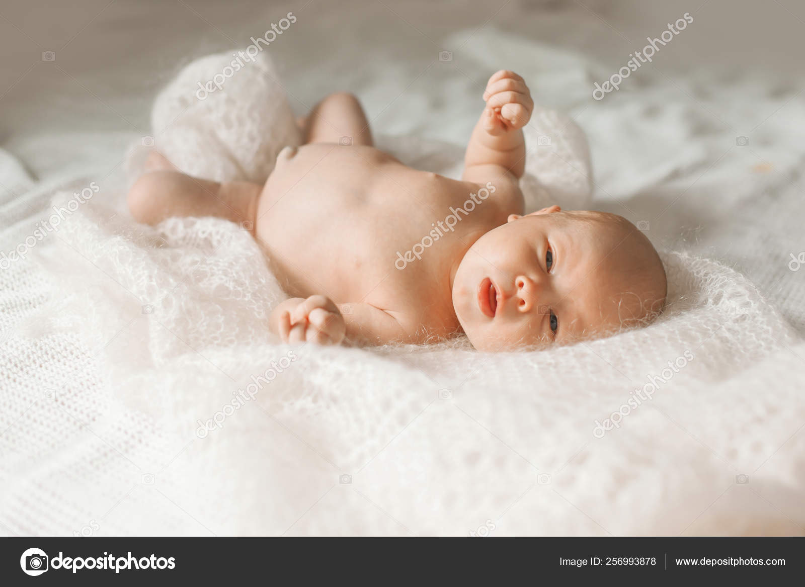 Curious newborn baby lying on the couch in the nursery — Stock Photo ...