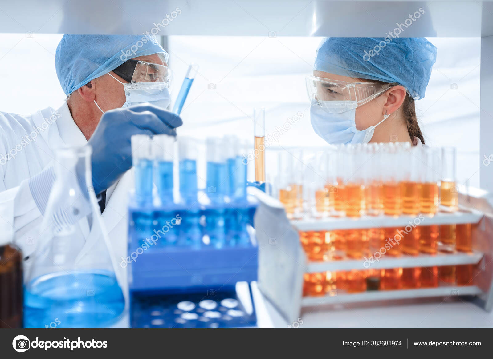 Close up. scientists with test tubes in a biochemical laboratory ...