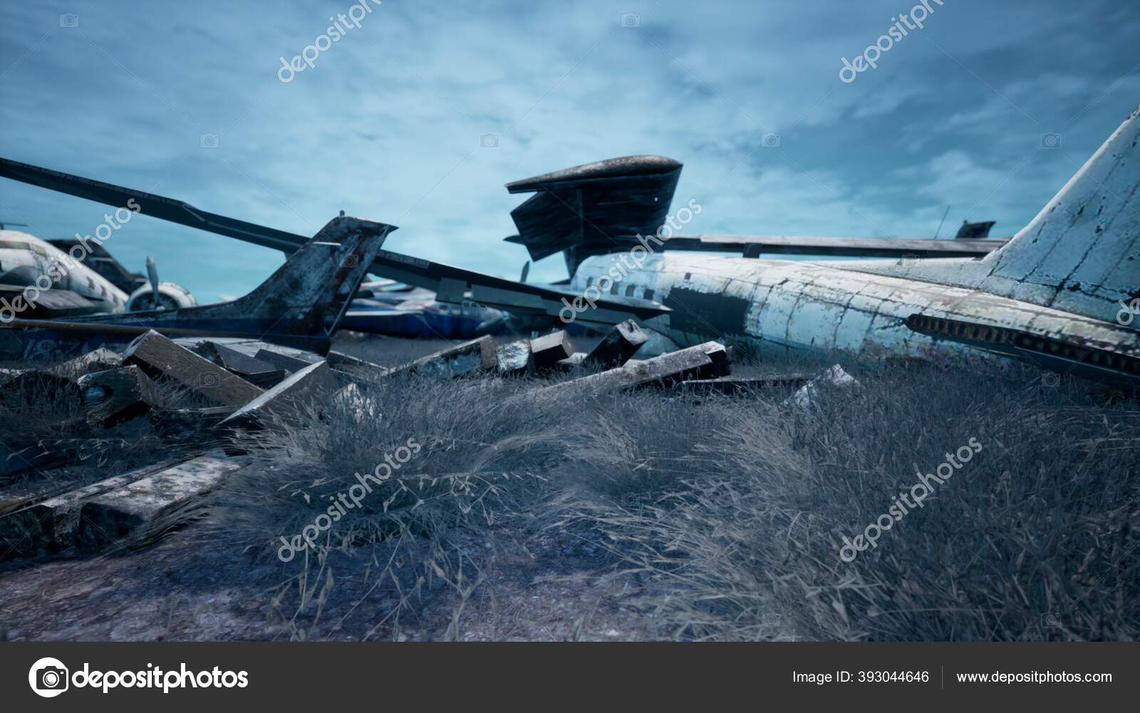 Rusty and broken planes stand in a field against a hazy blue sky. A lot ...