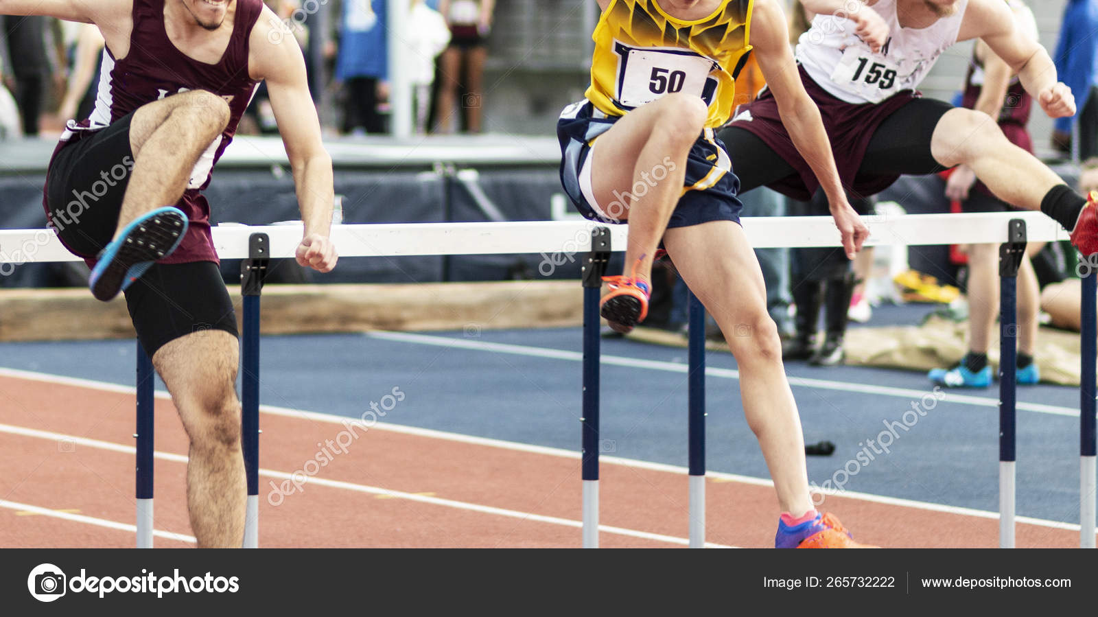 Three runners racing the hurdles indoors — Stock Photo © WoodysPhotos ...