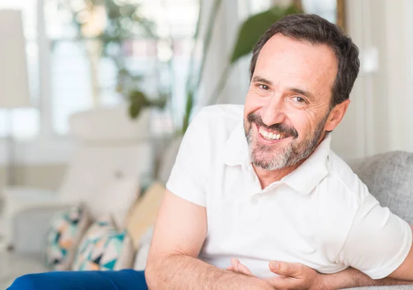 Handsome middle age man with a happy face standing and smiling with a ...