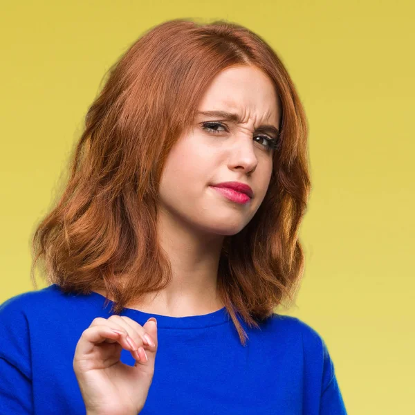 Young beautiful woman over isolated background disgusted expression ...