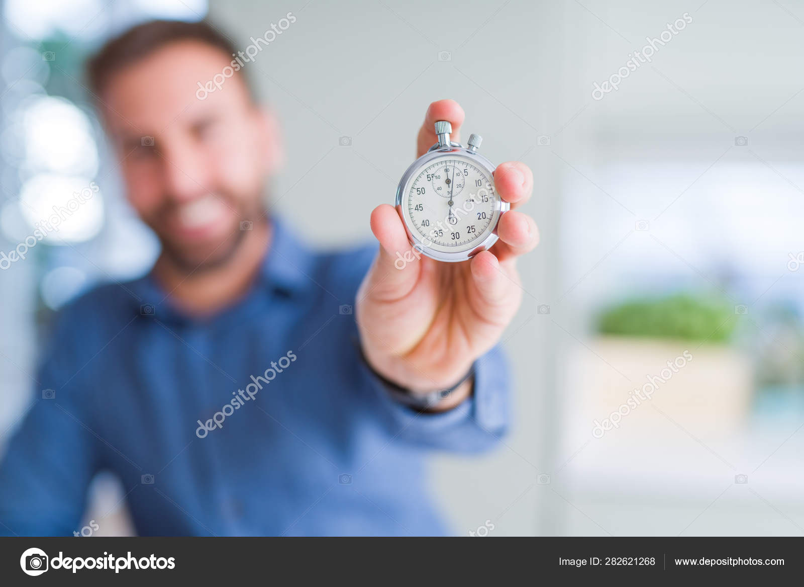 Handsome man showing stopwatch — Stock Photo © Krakenimages.com #282621268