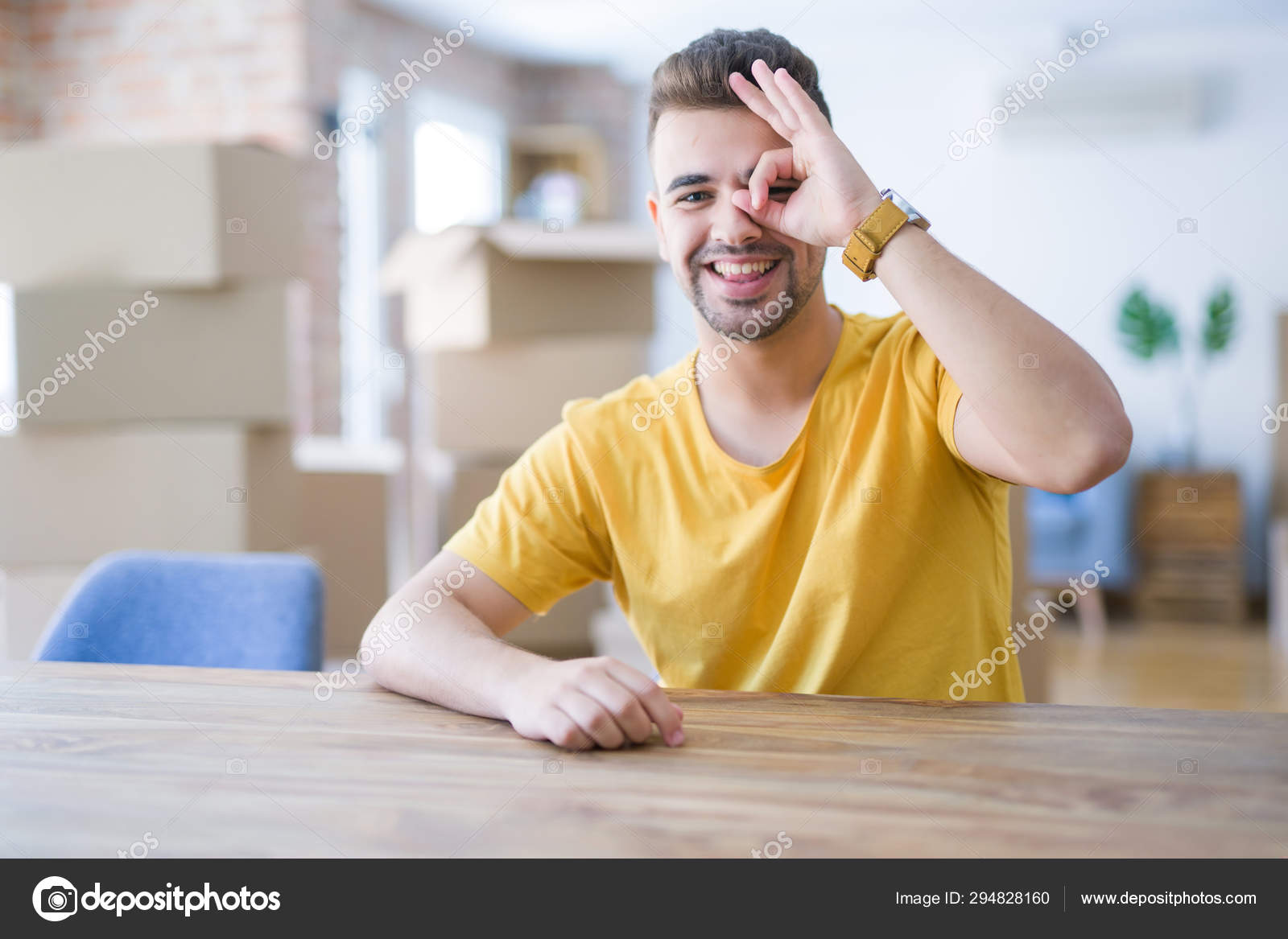 Young Man Sitting Table Cardboard Boxes Him Moving New Home Stock Photo ...
