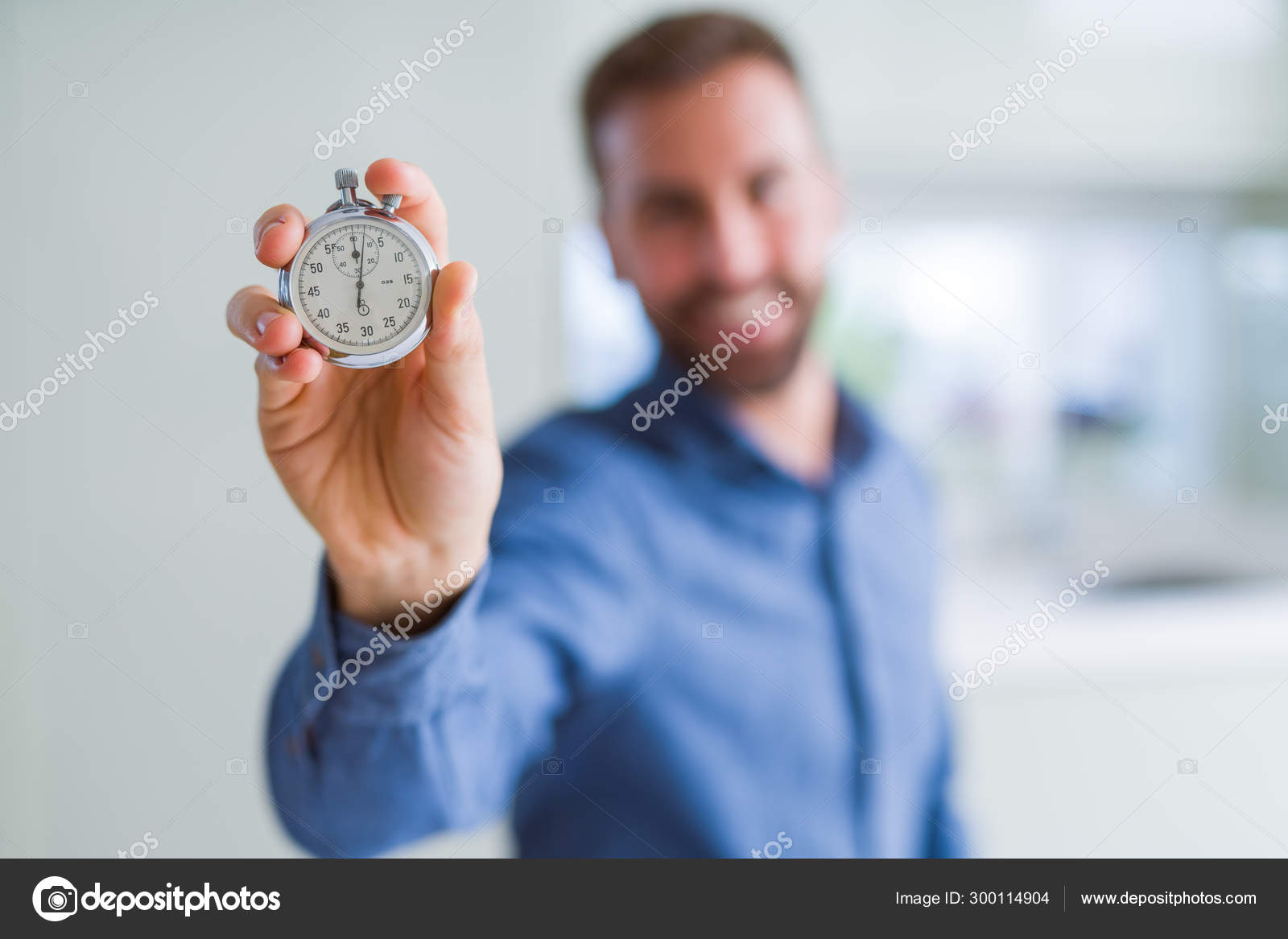 Handsome man showing stopwatch Stock Photo by ©Krakenimages.com 300114904