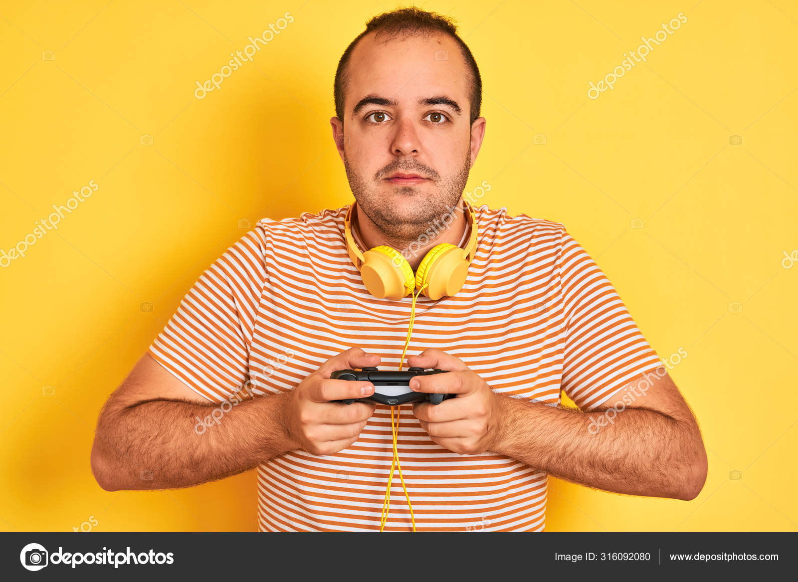 Young Gamer Man Playing Video Game Using Headphones Isolated Yellow ...