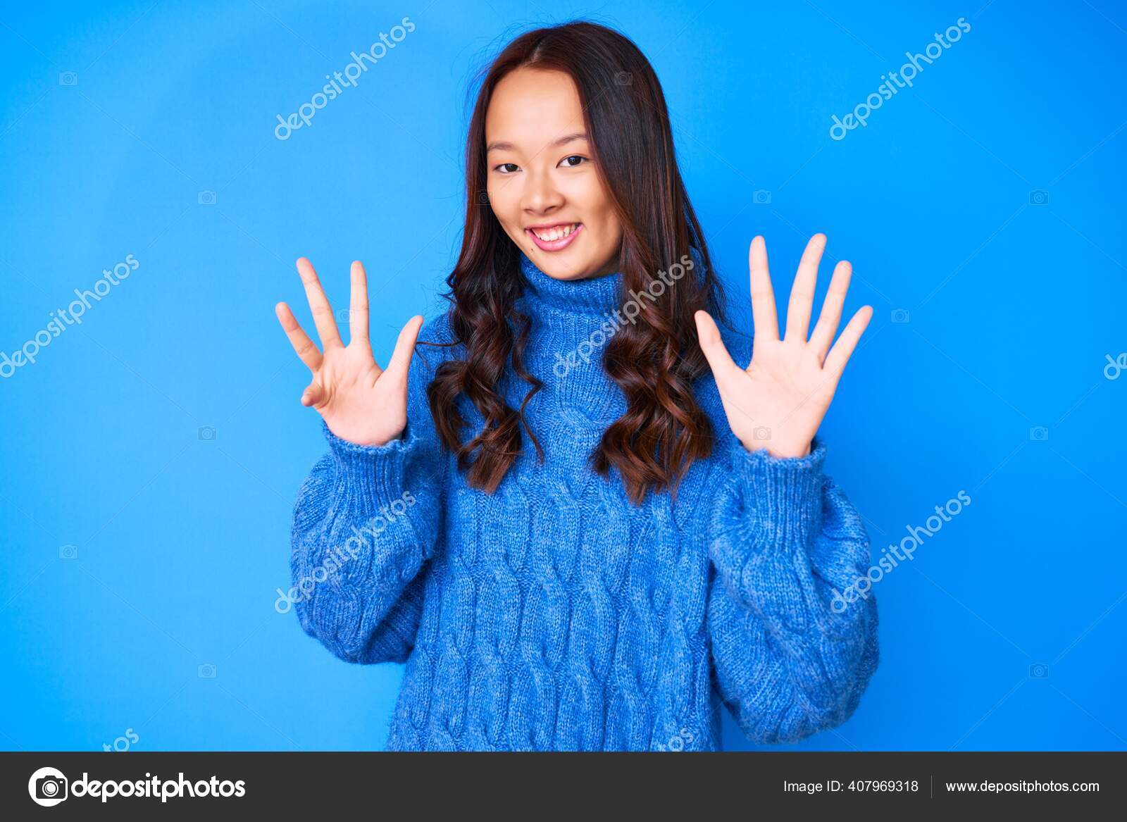 Young Beautiful Chinese Girl Wearing Casual Winter Sweater Showing