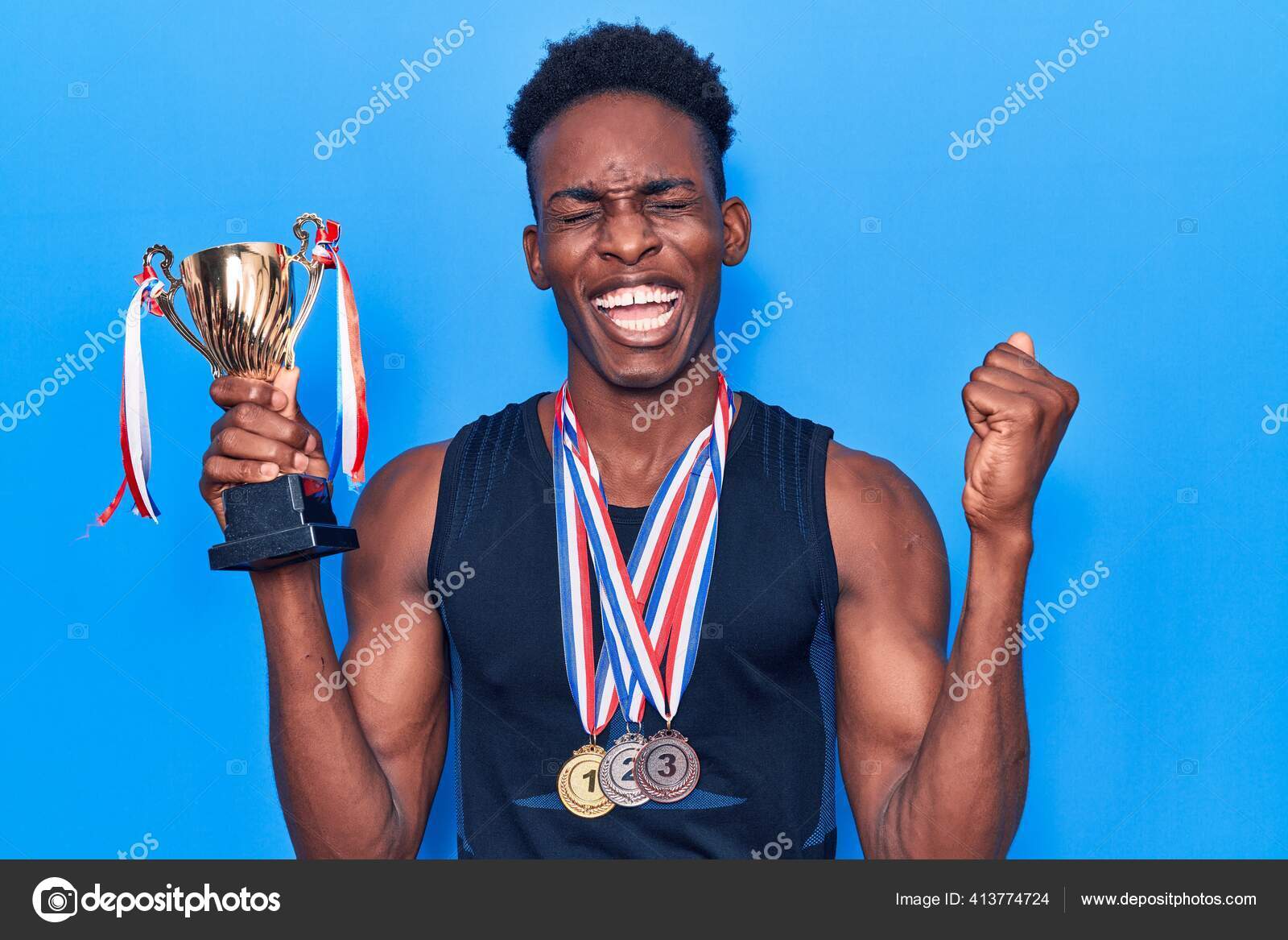 Young African American Man Holding Champion Trophy Wearing Medals ...