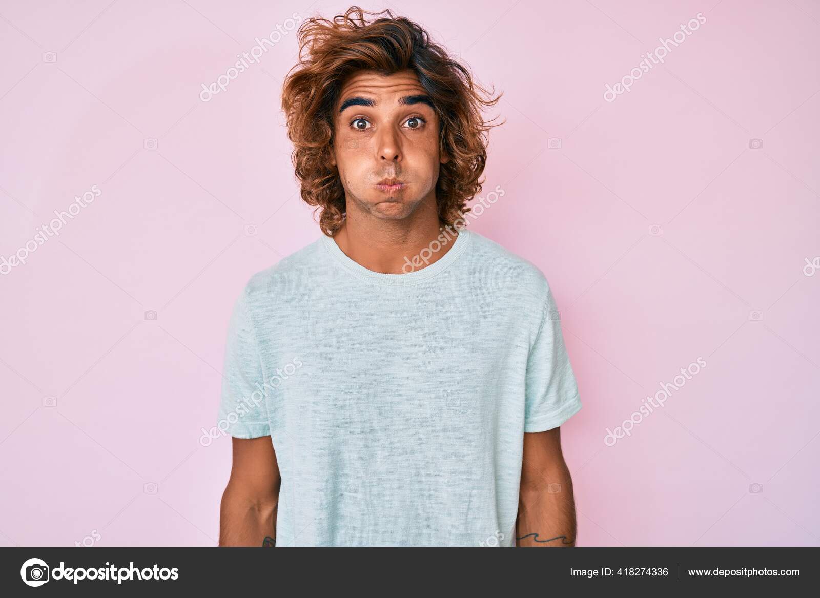 Young Hispanic Man Wearing Casual Clothes Puffing Cheeks Funny Face ...