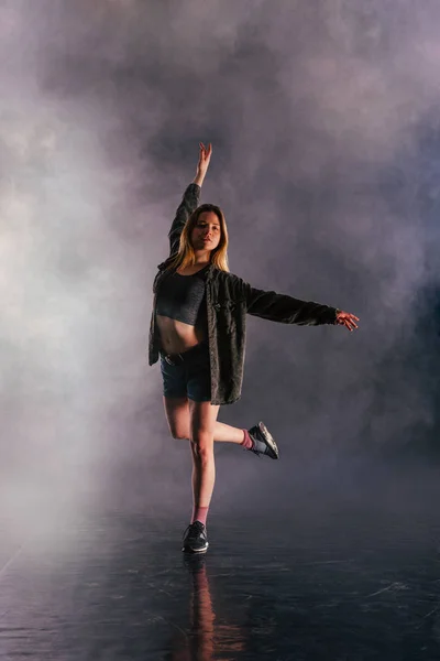 Shoeless female dance shows off her modern art dance moves while ...