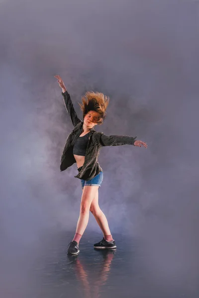 Shoeless female dance shows off her modern art dance moves while ...