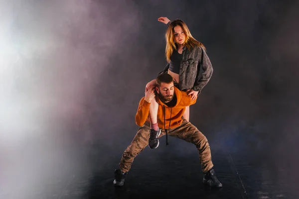 Strong male dancer and an elegant female dancer perform an exoti ...