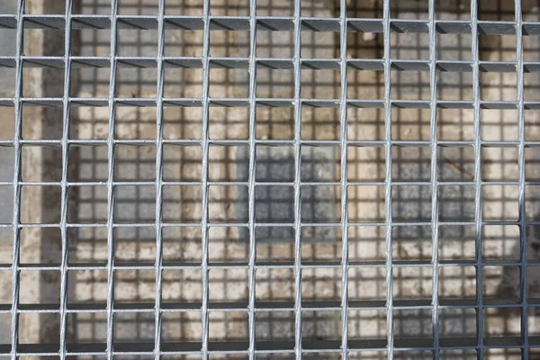 Close-up of a gray metal grating. - Stock Image - Everypixel