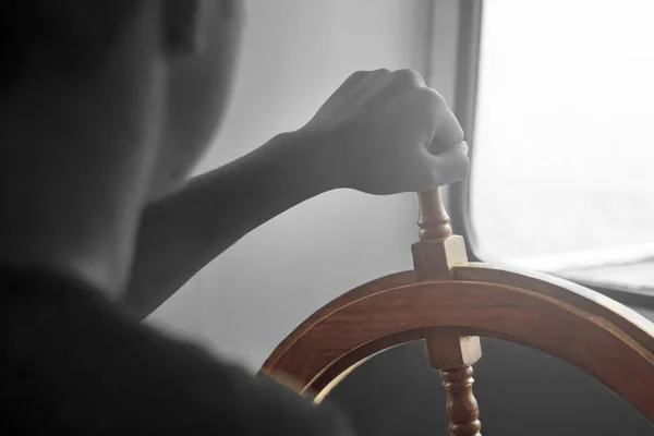 A small motor ship. Steering wheel from retro wood. Shallow depth of ...