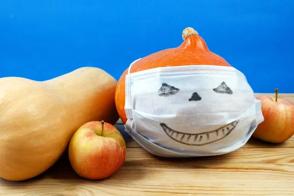 pumpkin wearing a face mask for protection from coronavirus witth ...