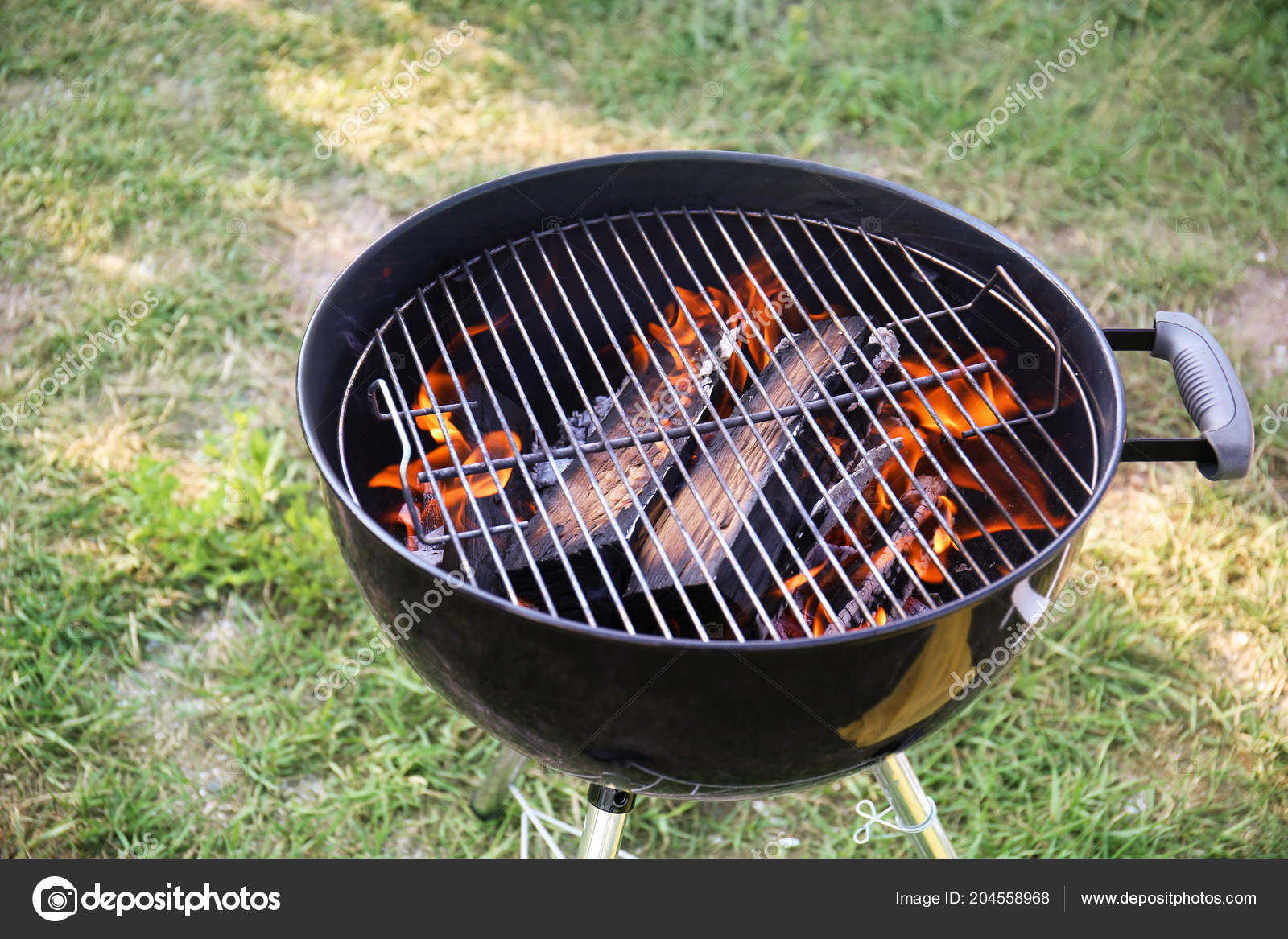 Modern Barbecue Grill Burning Firewood Outdoors Stock Photo by ...