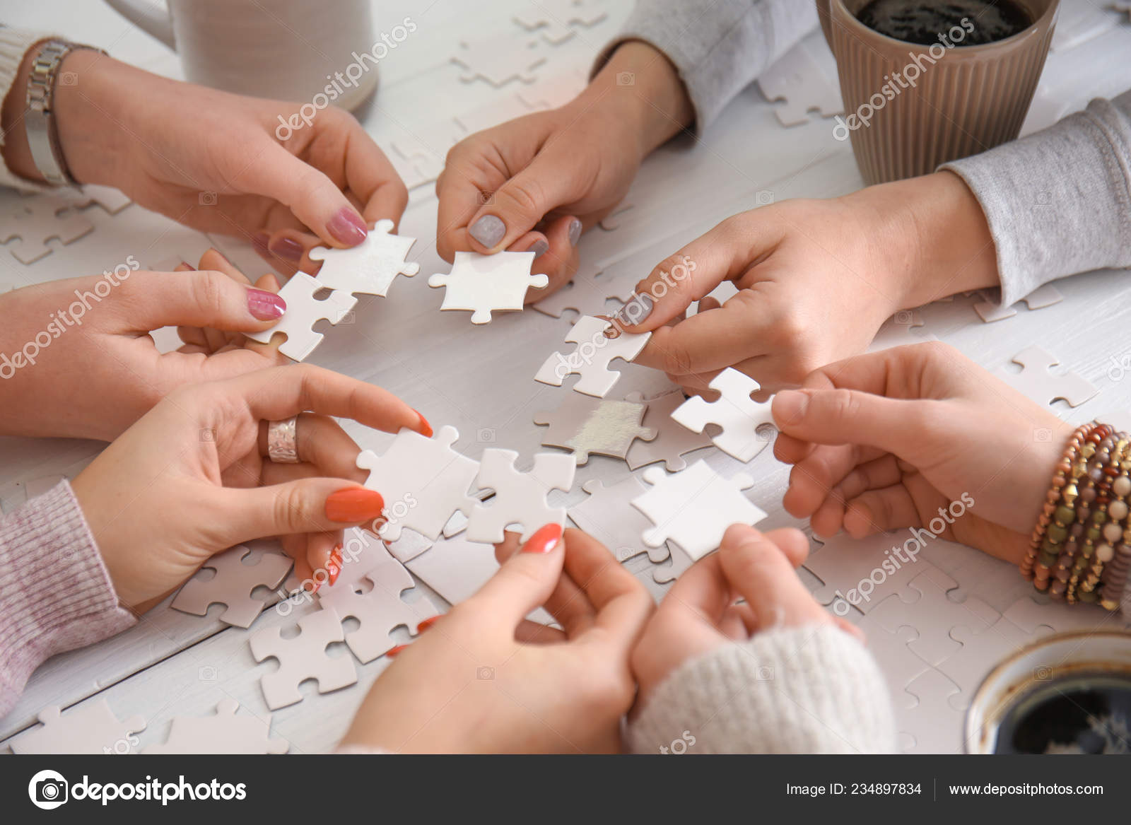 People Doing Puzzle Table Stock Photo by ©serezniy 234897834